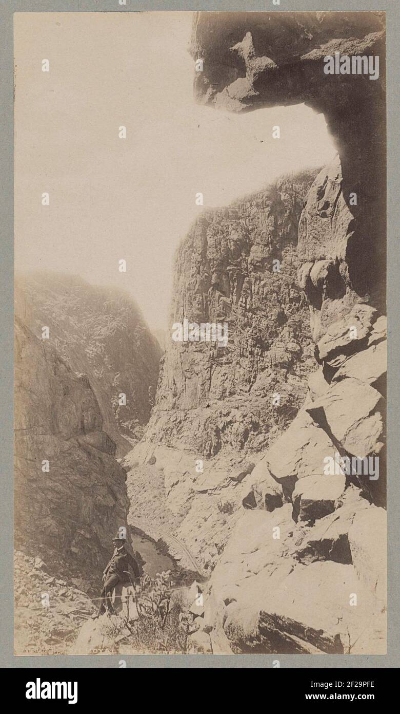 Man in a North American gorge with a railway line in depth (presumably ...