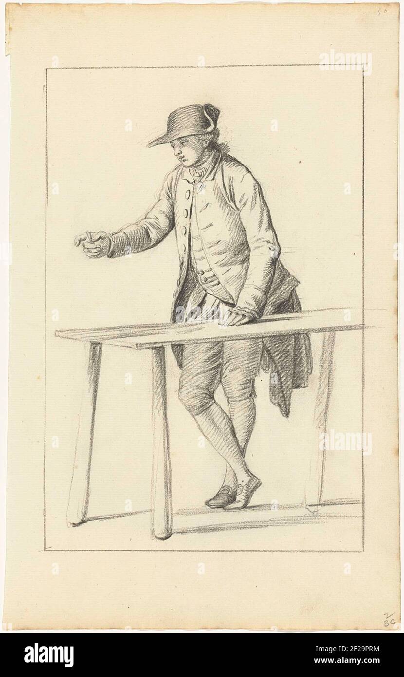 Standing, pointing man at table Stock Photo - Alamy