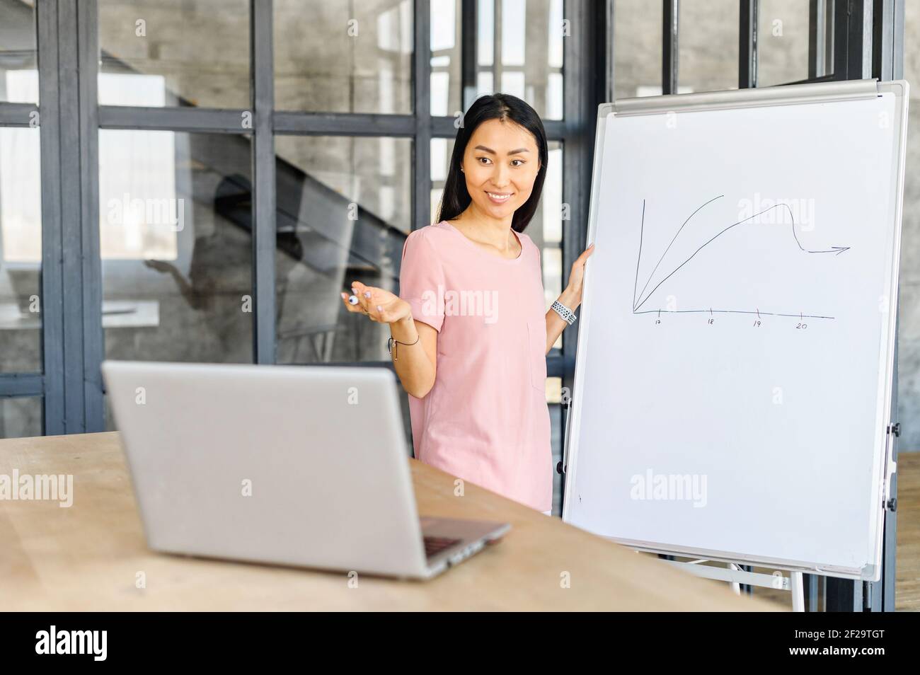 Modern young Asian female school teacher streaming lesson online ...