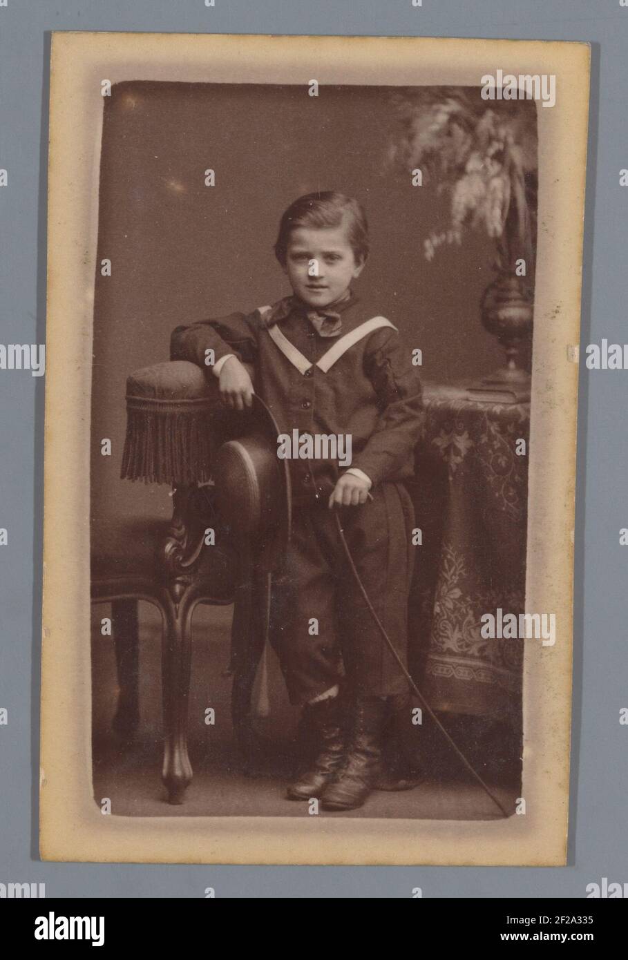 Portrait of an unknown boy with a hat and a stick in his hands Stock ...