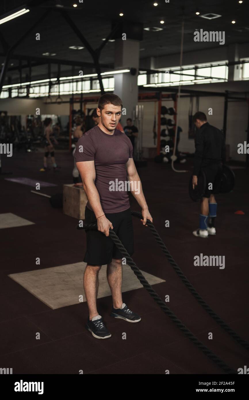 Vertical shot of a handsome muscular athletic man resting after ...