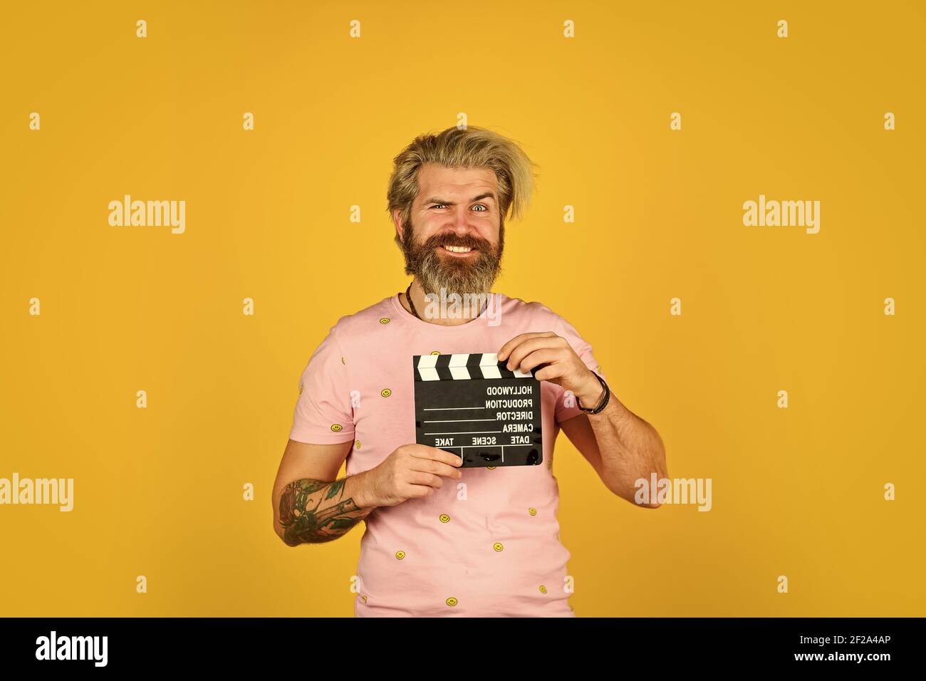 go to cinema. man with movie clapper. bearded guy with film making ...