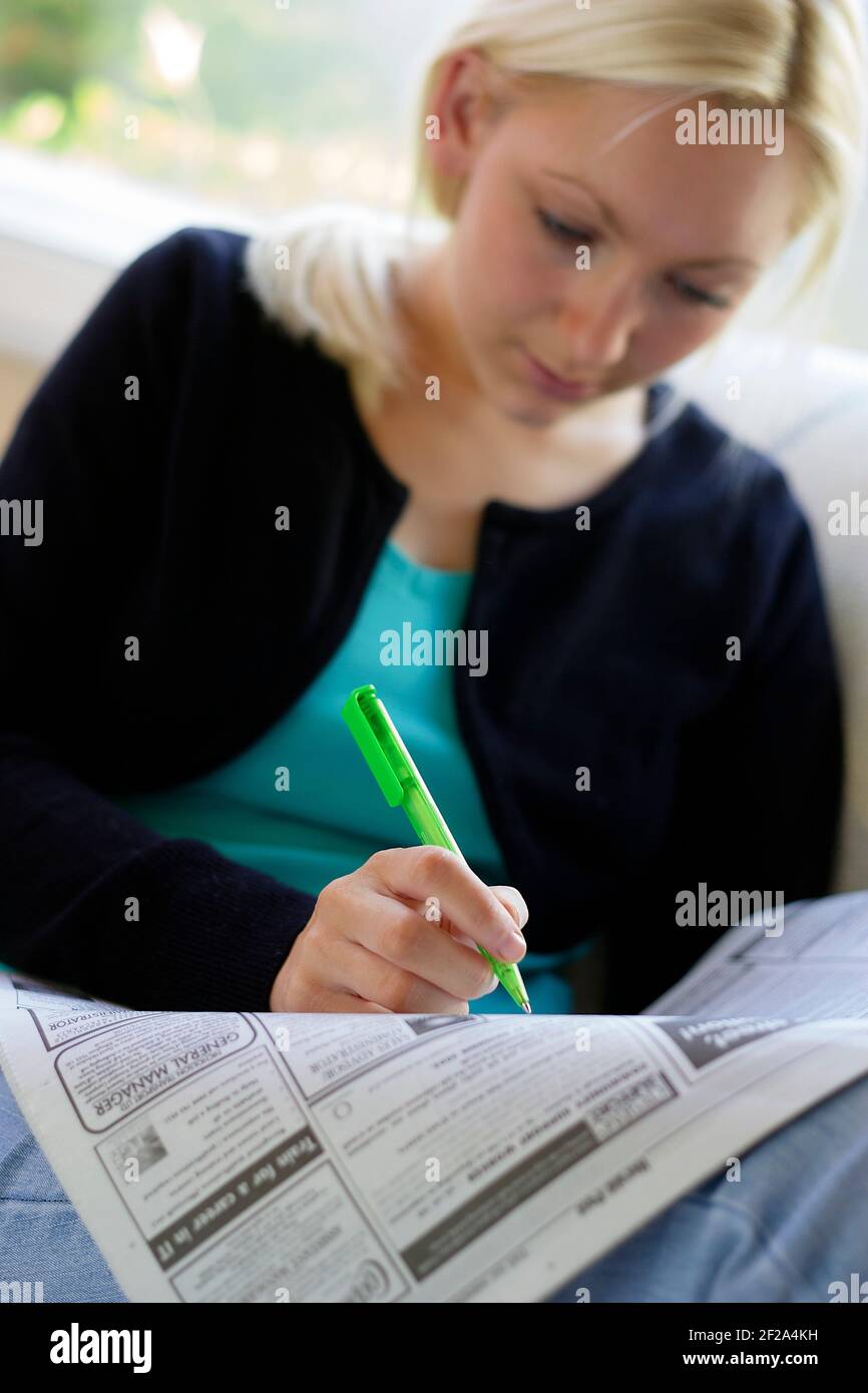 Blonde girl reading newspaper hi-res stock photography and images - Alamy