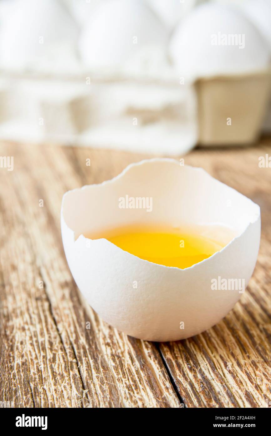 Close-up of fresh egg yolk on the background of eggs in paper tray on ...