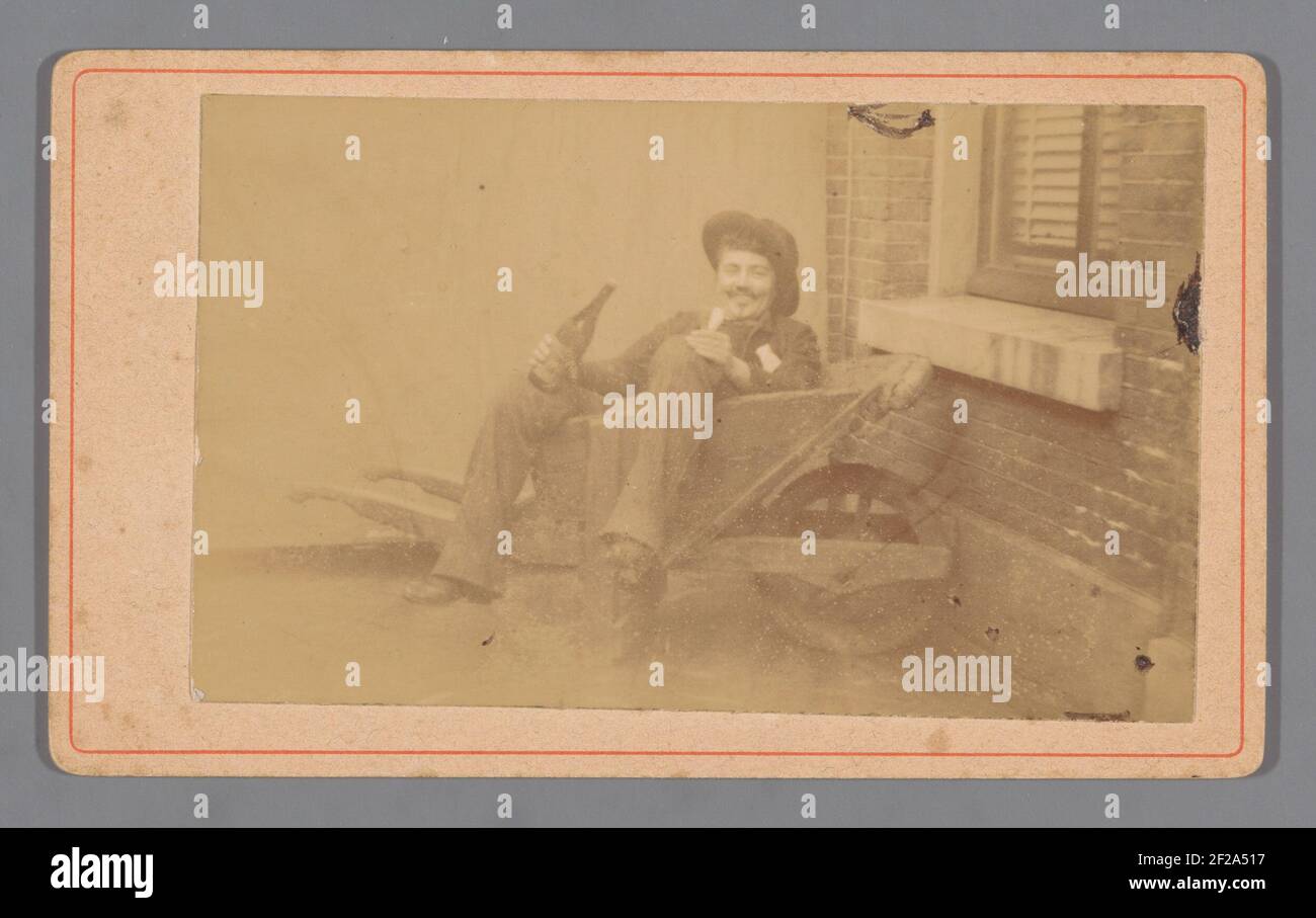 Man (in reality a dressed woman?) With bottle and glass in a ...