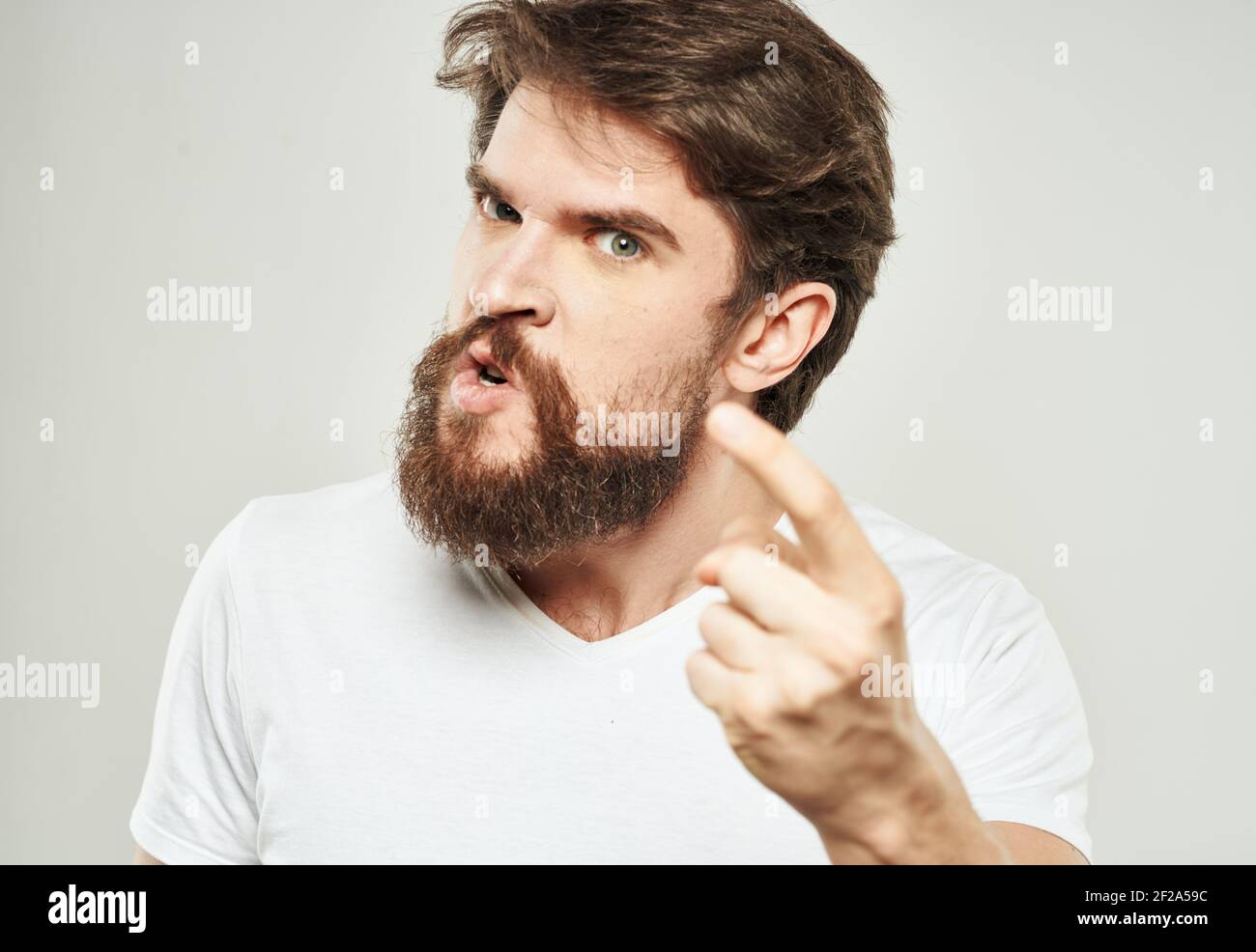The guy in the T-shirt shows the index finger and emotions model an ...