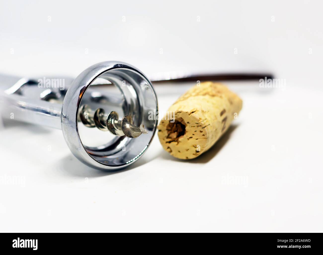 steel wing corkscrew with a perforated cork isolated on a white ...