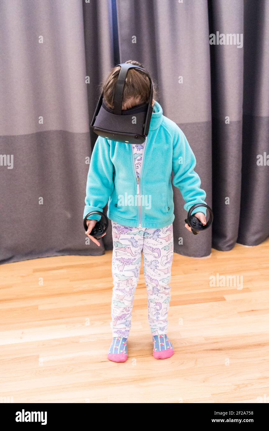 Little girl playing VR kids game in the living room Stock Photo - Alamy