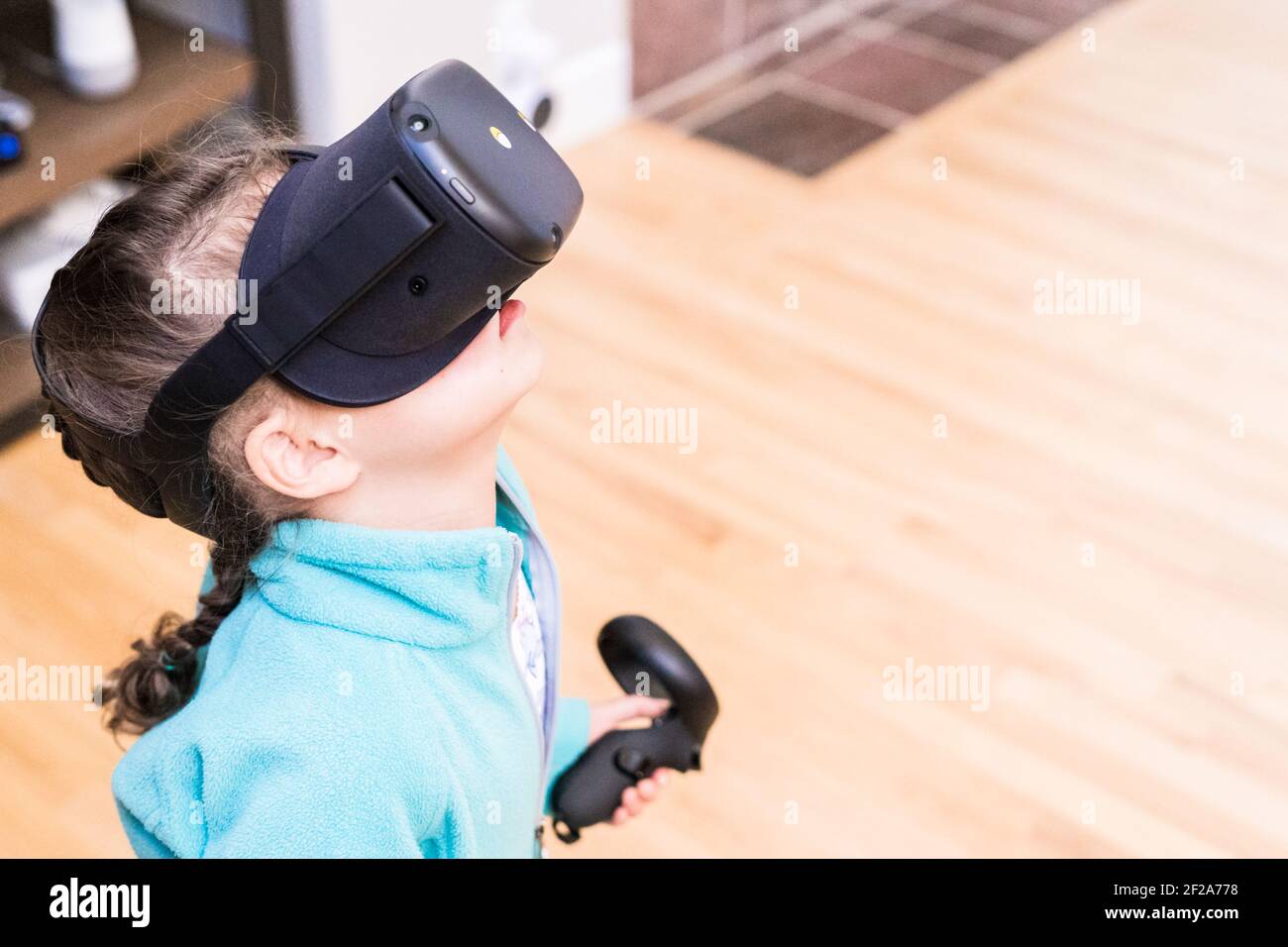 Little girl playing VR kids game in the living room Stock Photo - Alamy