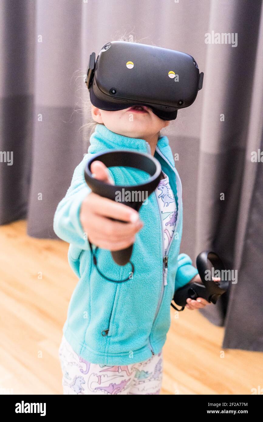 Little girl playing VR kids game in the living room Stock Photo - Alamy