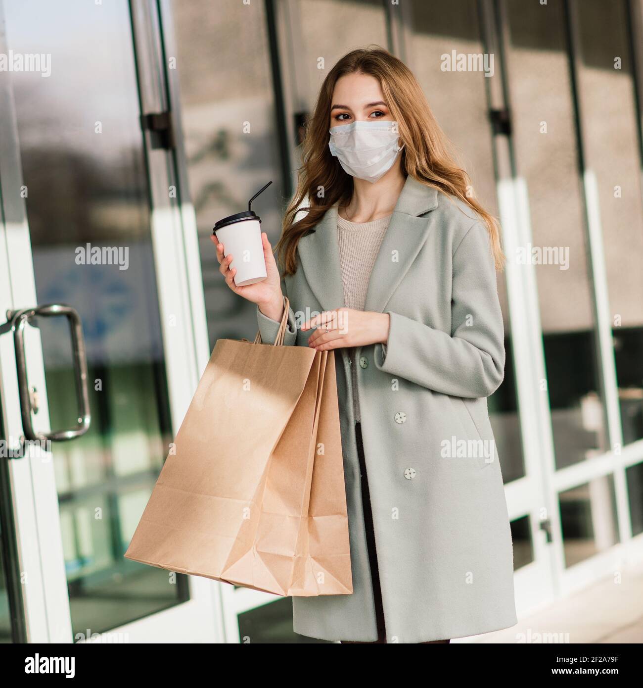 Young female wearing mask for prevent virus with shopping bags on ...