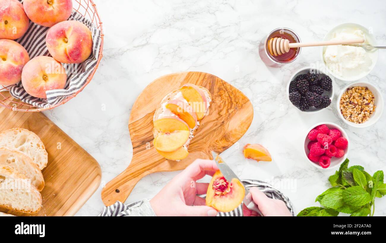 Flat lay. Step by step. Making ricotta toasts with organic peaches and ...