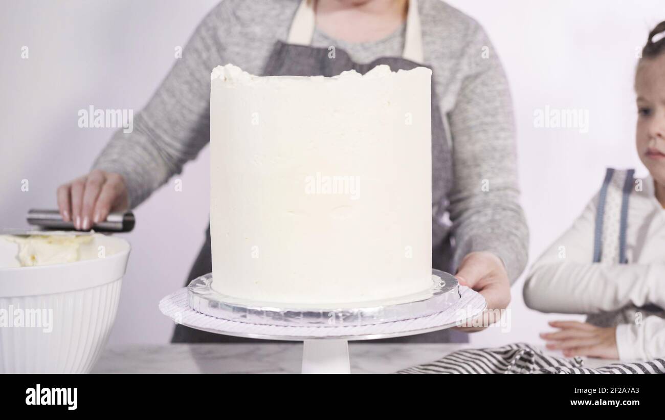 Step by step. Frosting round funfetti cake with white italian ...