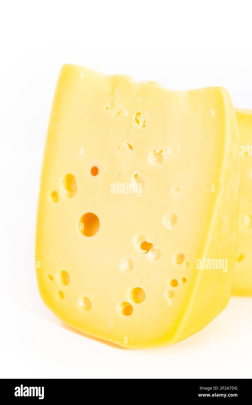 Large slice of semi soft part skim cheese on a white background Stock ...