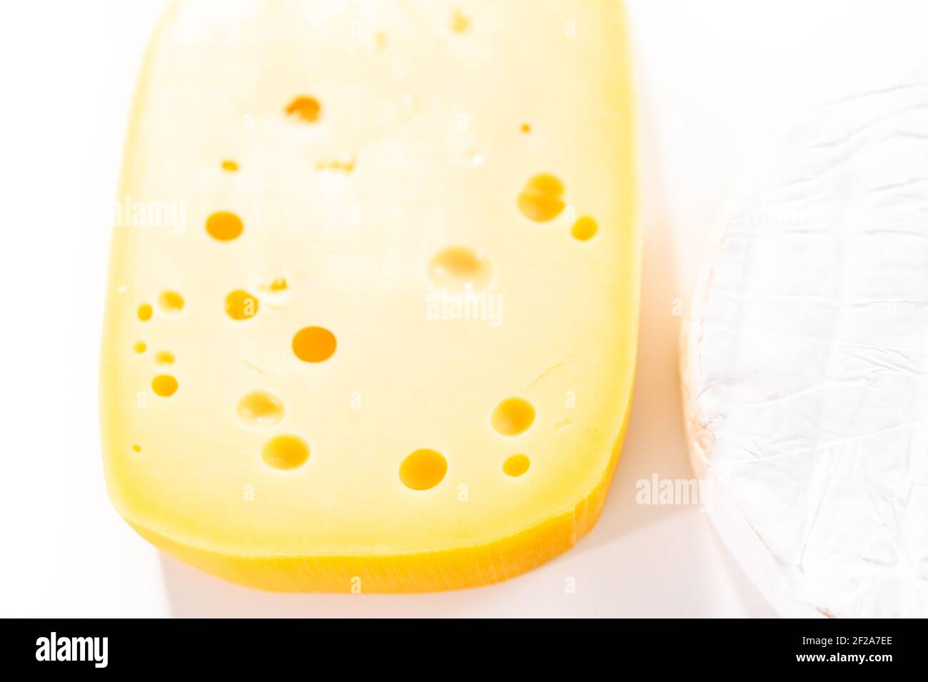 Large slice of semi soft part skim cheese on a white background Stock ...