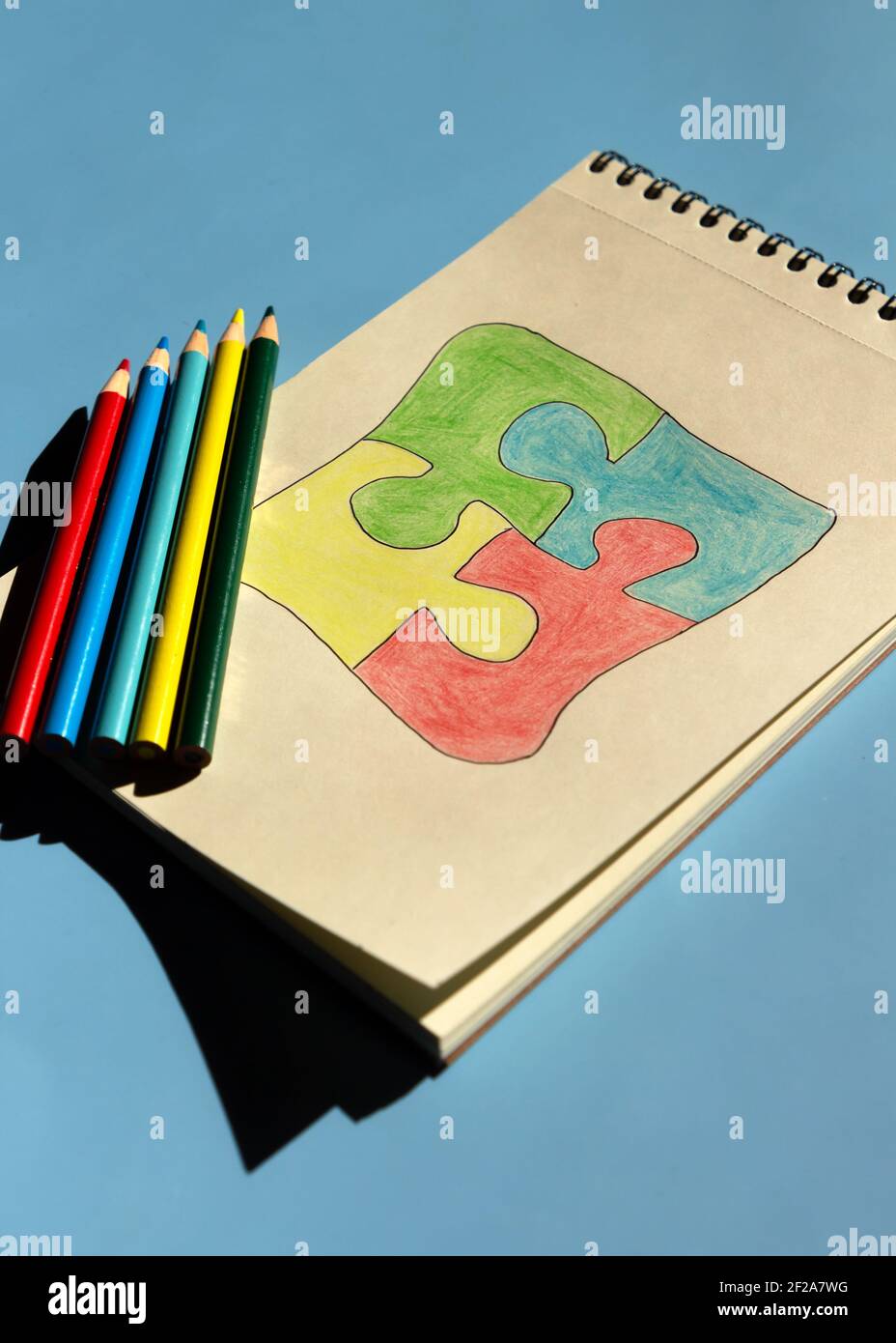 Autism awareness day or month. The drawn puzzle is colored in different ...