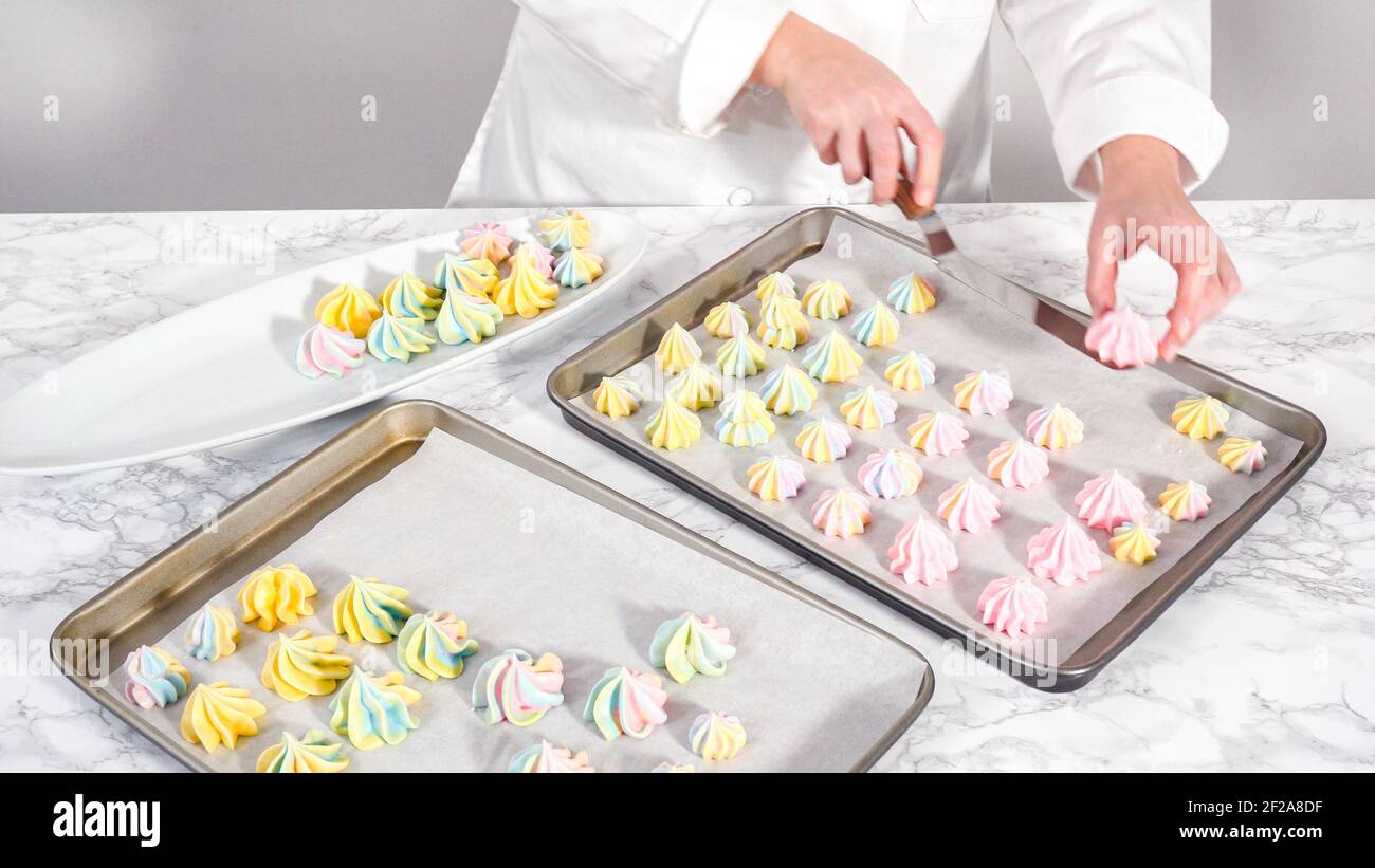 Step by step. Freshly baked unicorn meringue cookies on a baking sheet ...