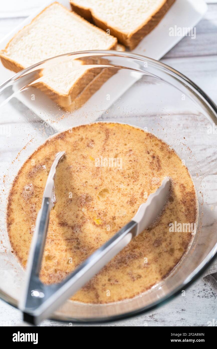 French toast batter in a large glass mixing bowl Stock Photo - Alamy