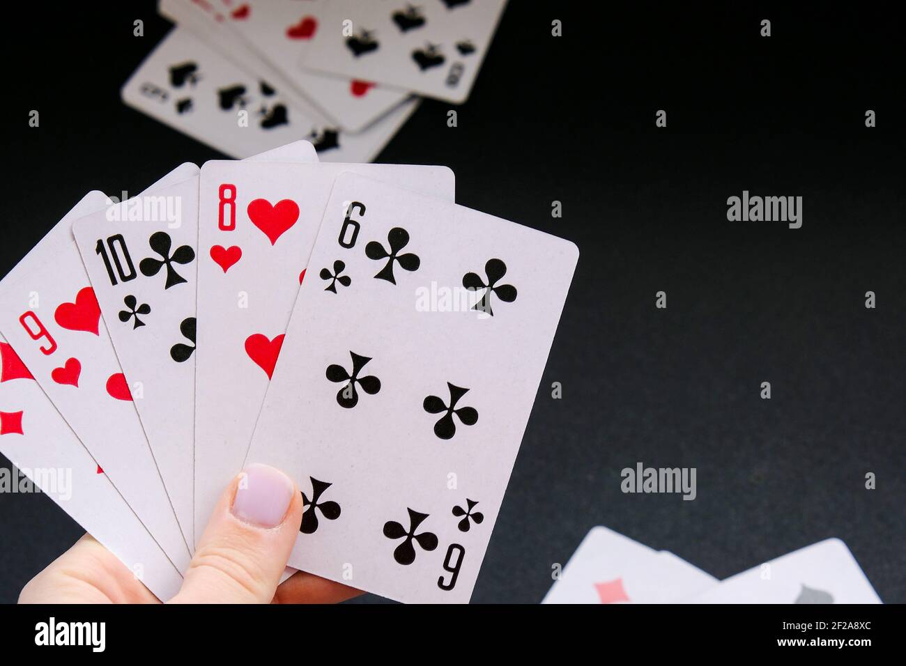 Female hand holding playing cards. Pastime with friends. Table games ...