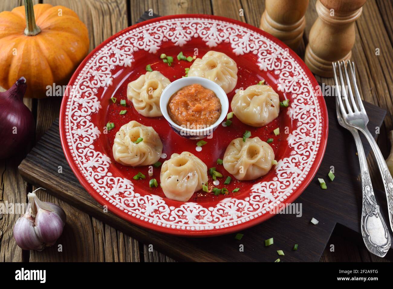 Traditional Asian food. Nepalese dumplings momo with curry sauce served ...