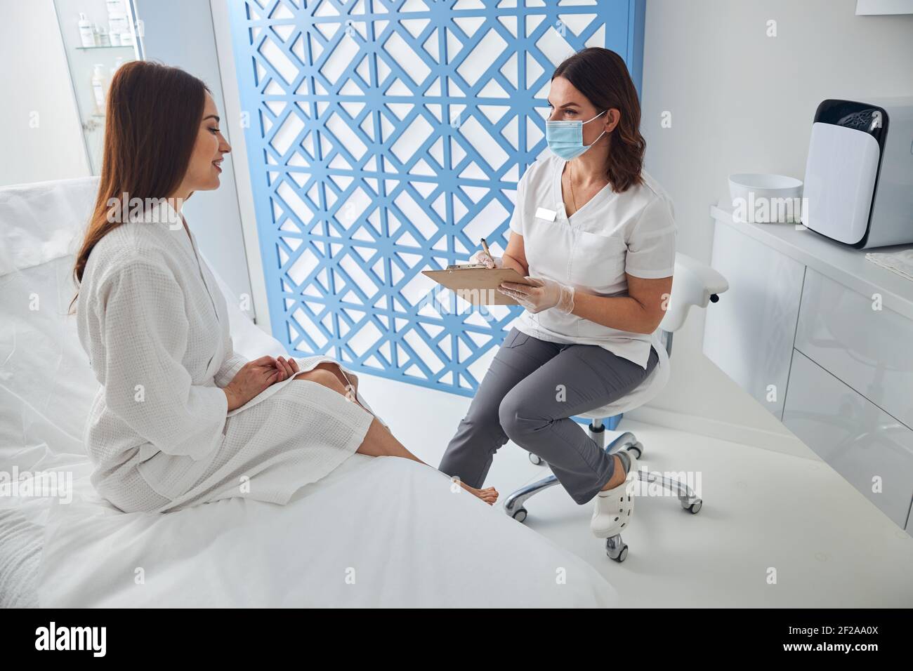 Beautiful woman having appointment with doctor in clinic Stock Photo ...