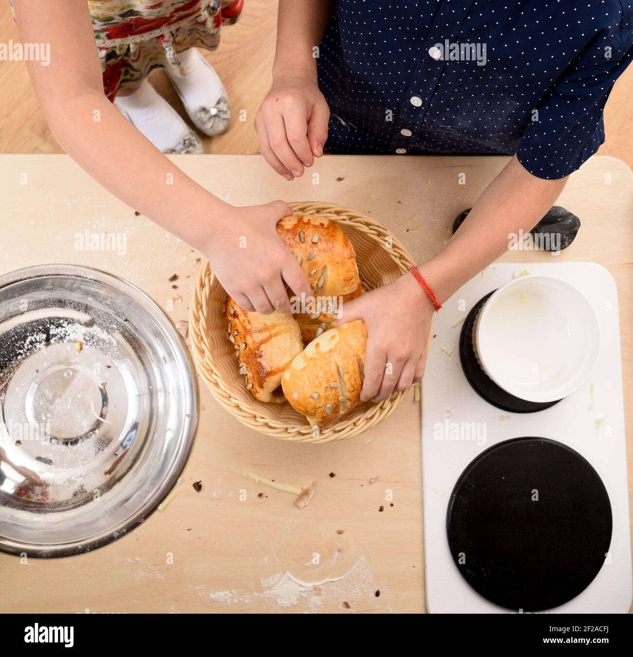 Children play in kitchen. Boy and girl with bread rolls in toy kitchen ...