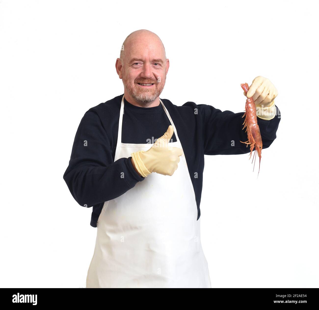 portrait of a fishmonger showing and ok sign a prawns on white ...
