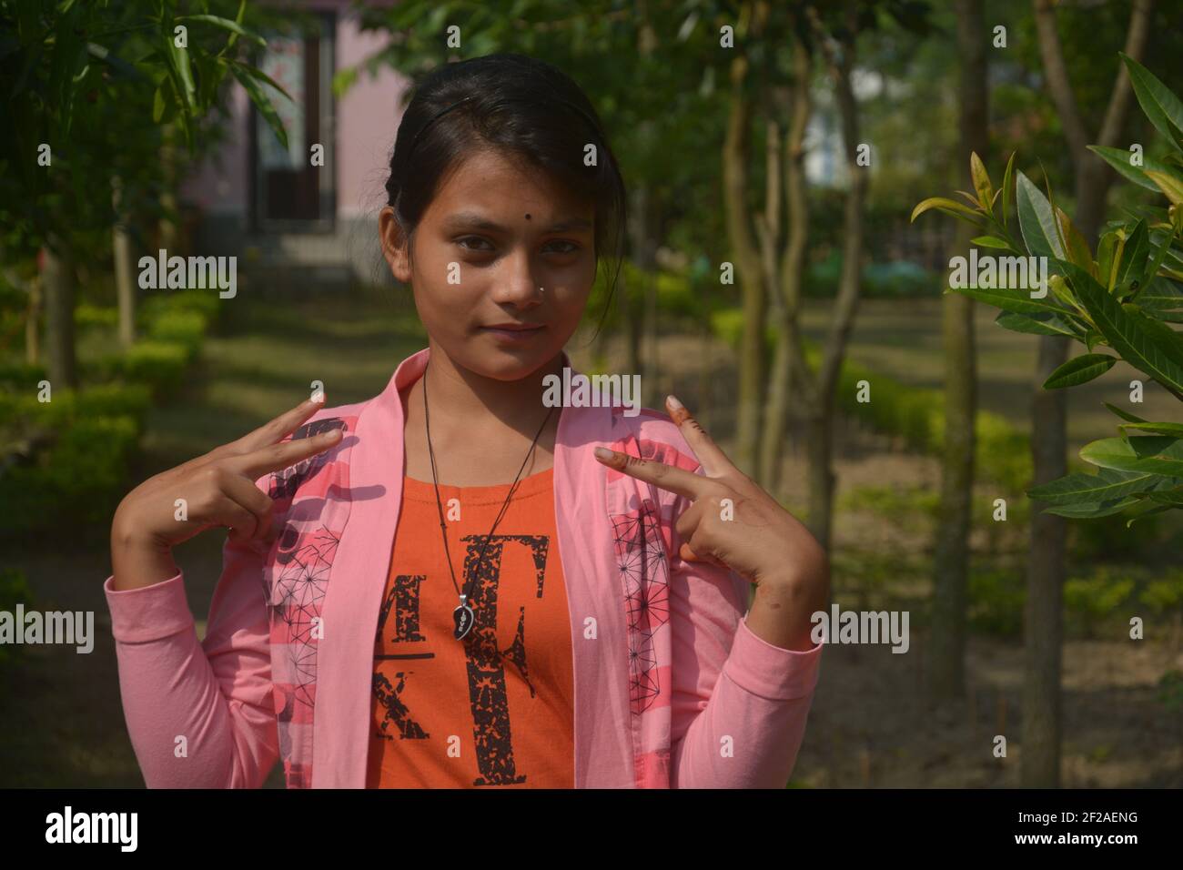 Close up beautiful Indian Bengali teenage girl wearing pink dress ...
