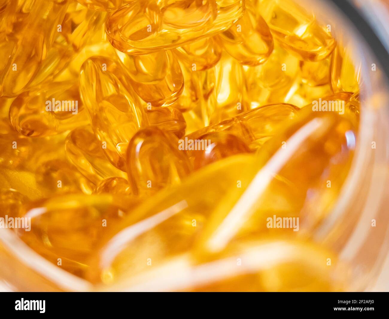 Yellow pills spilling in drug bottle, close-up. Top down view. Colorful ...