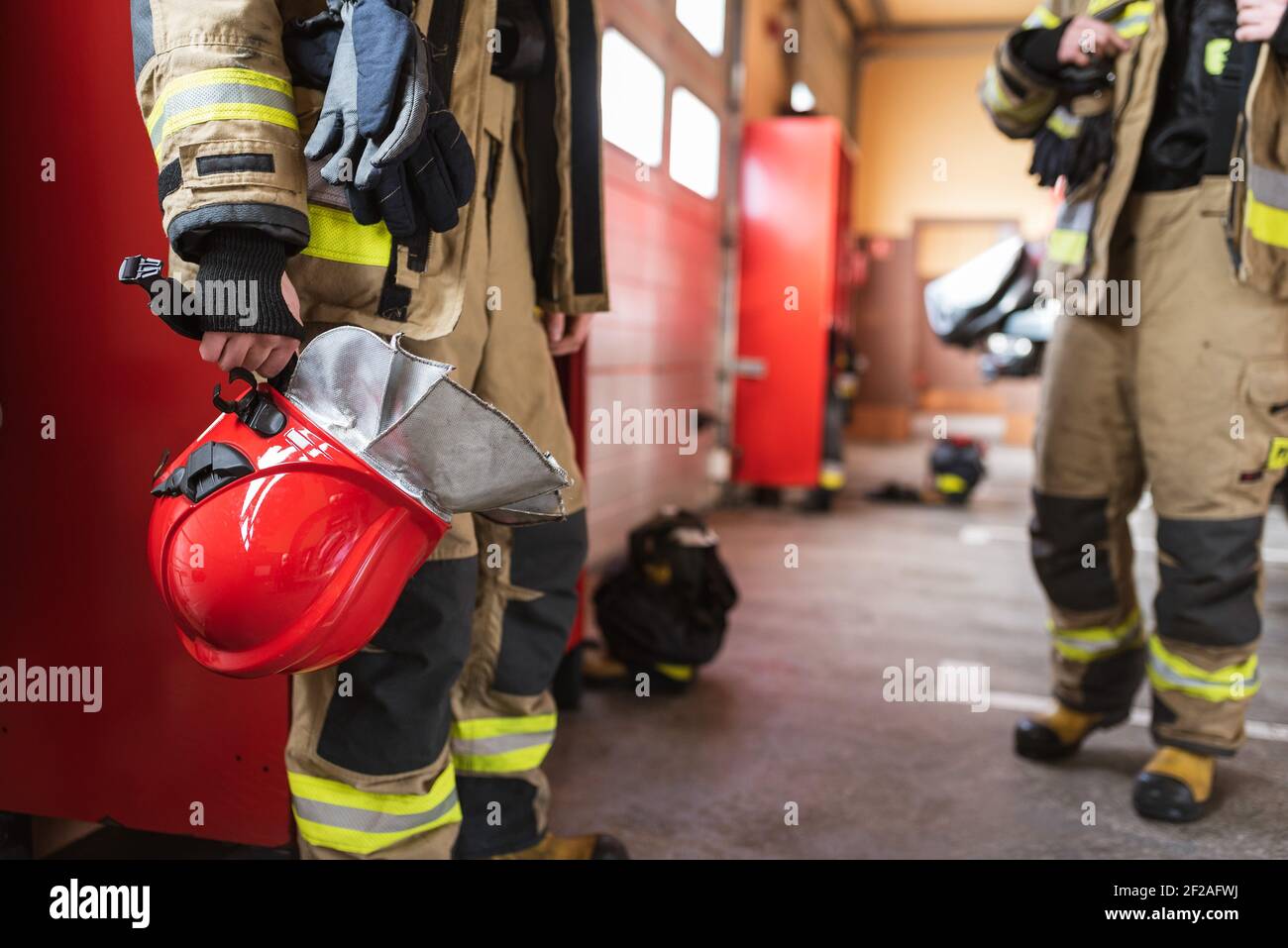 Red helmet in fireman's hand Stock Photo - Alamy