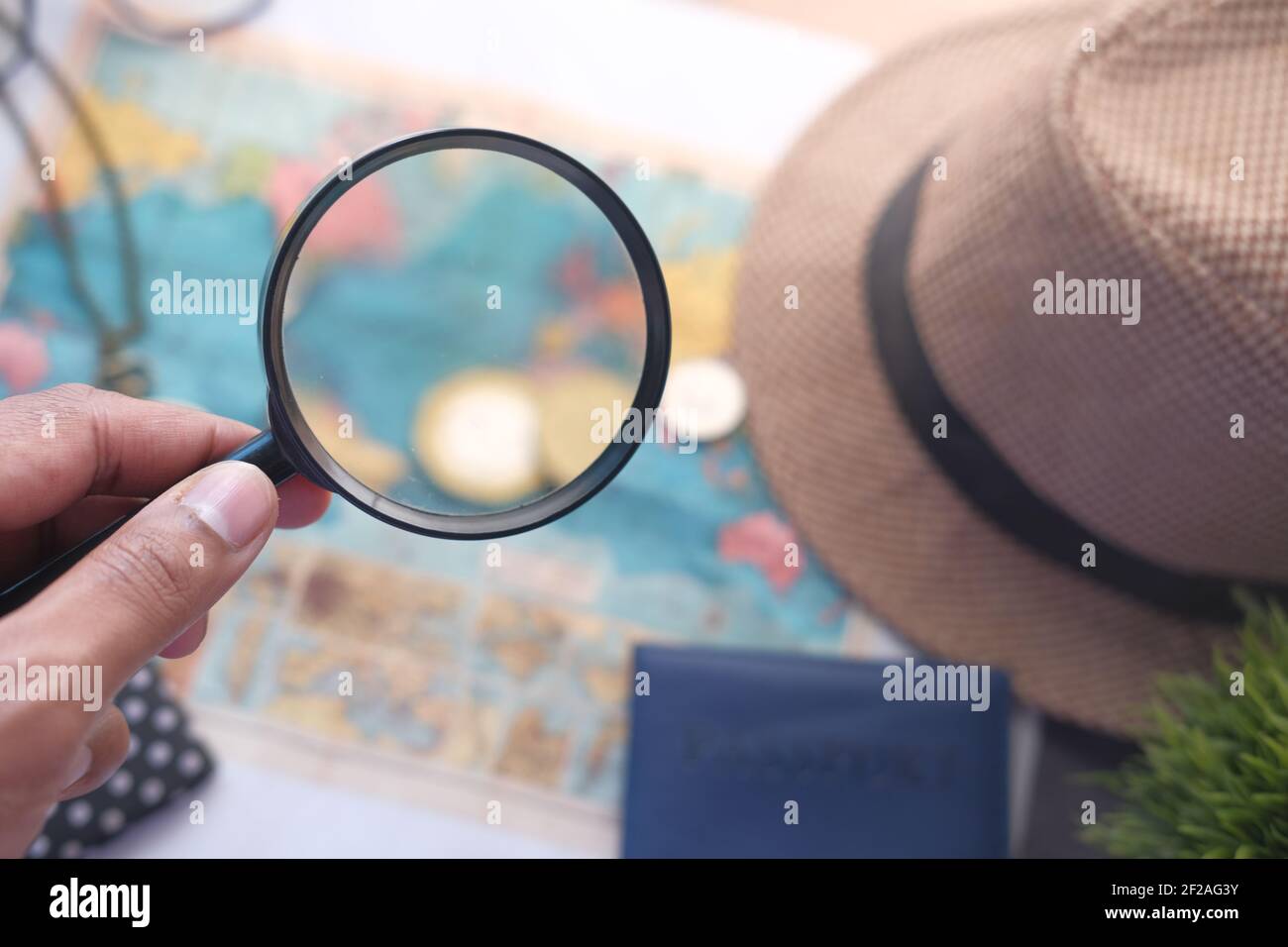 young man using magnifying glass looking something on map Stock Photo ...
