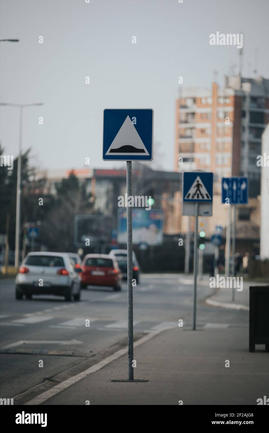 A vertical shot of three different transportation signs on the street ...