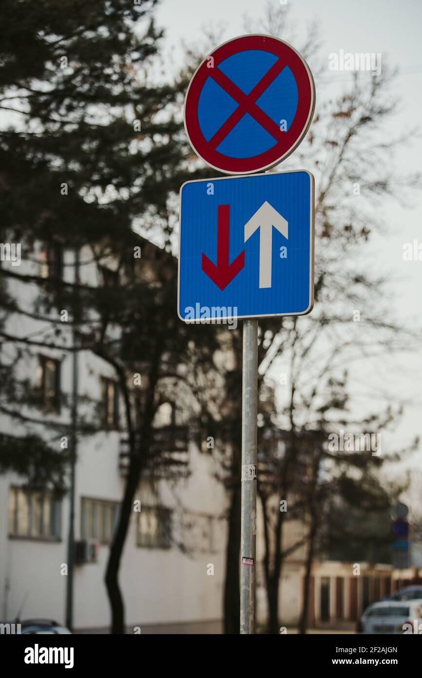 A vertical shot of two different shaped road signs on the street Stock ...