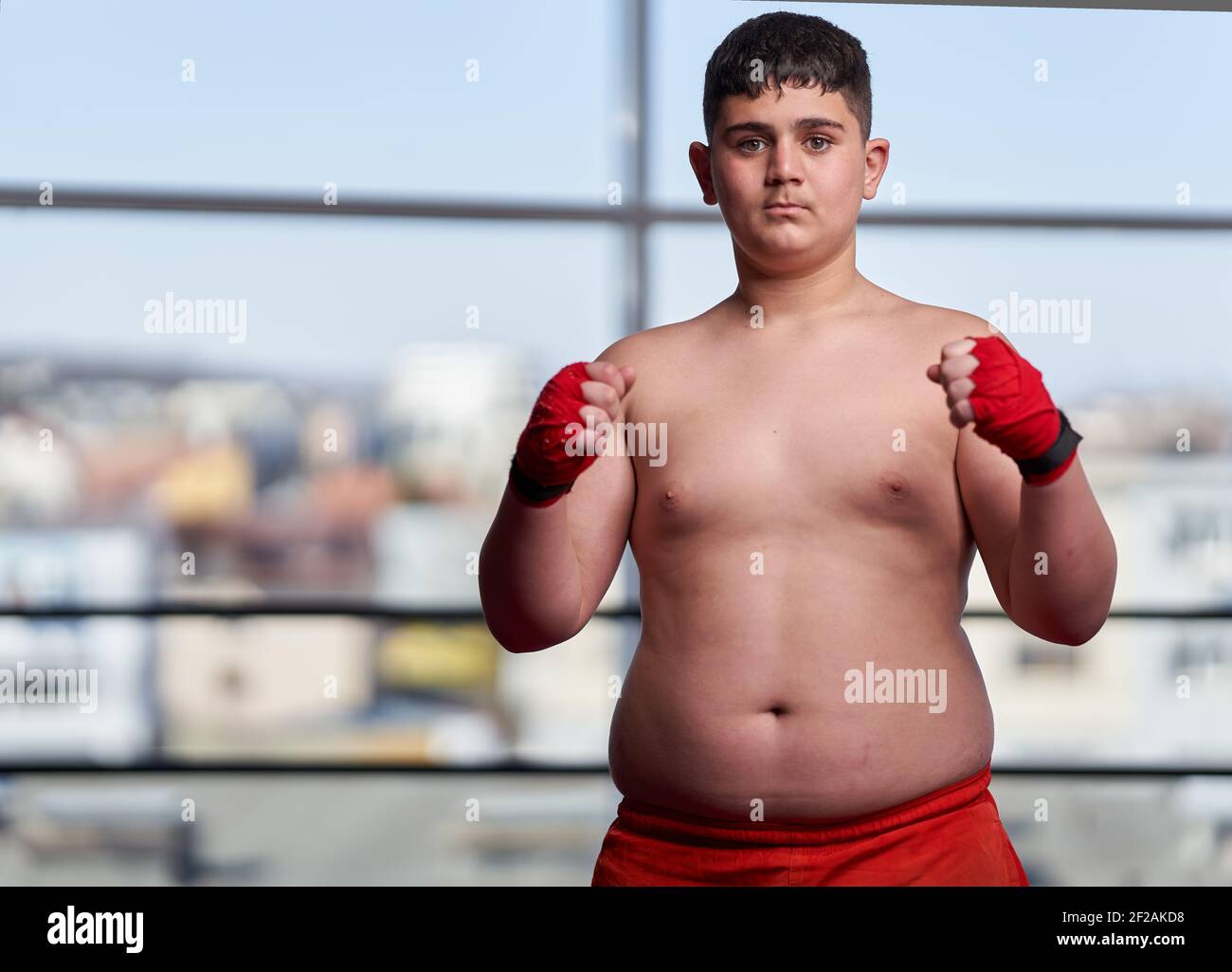Young overweight confident boxer posing in the gym Stock Photo - Alamy