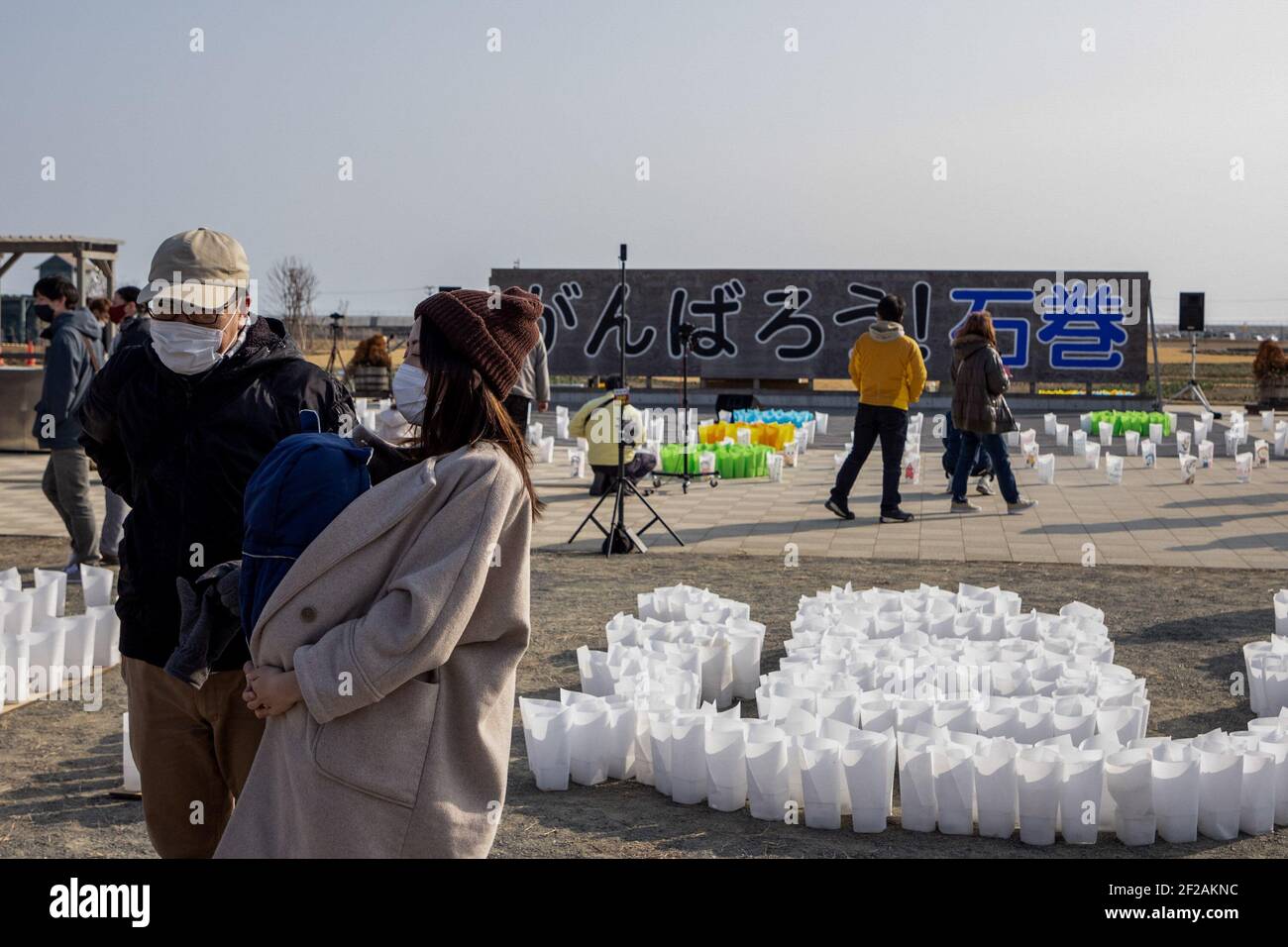 Families and friends come and search for names and offer flowers and ...