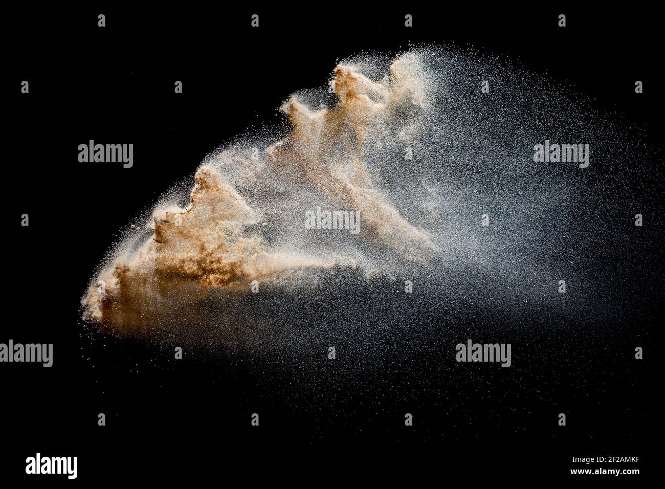 Sand explosion isolated on black background. Freeze motion of sandy ...