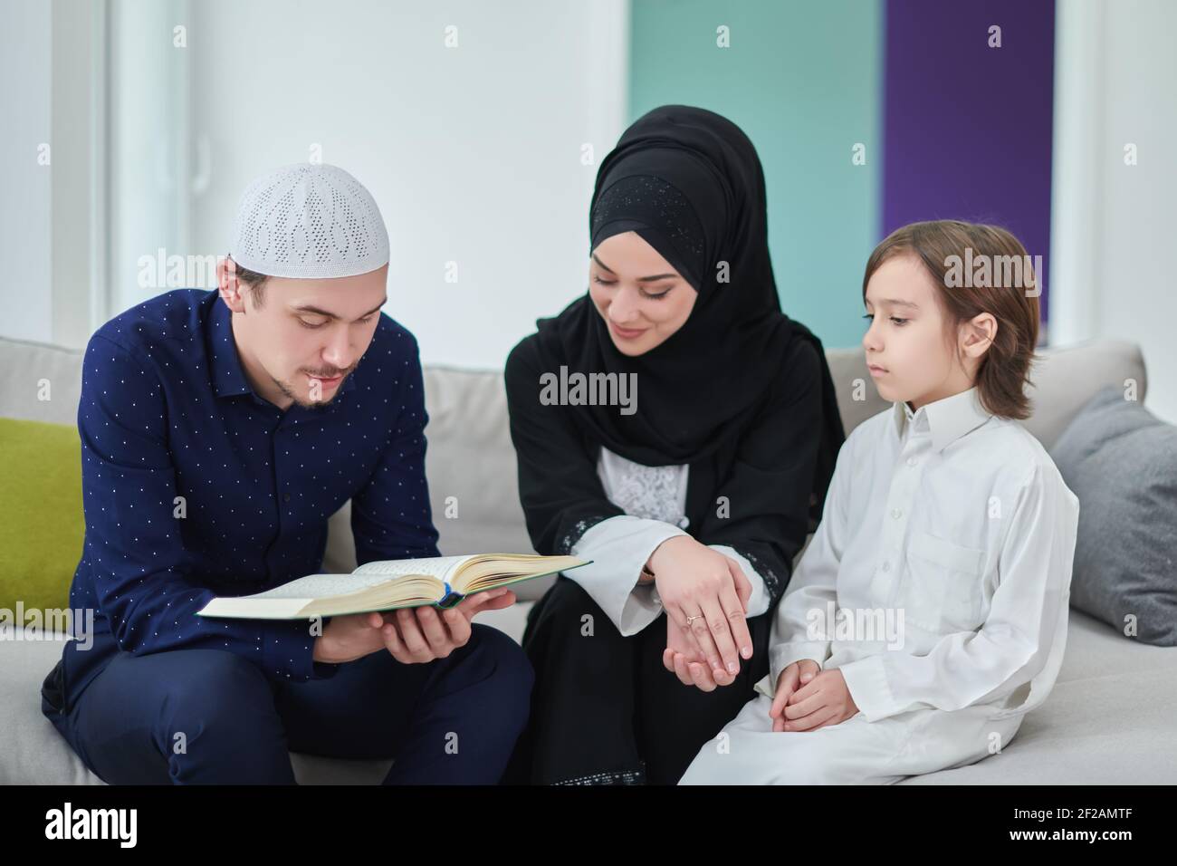 Young muslim family reading Quran during Ramadan Stock Photo - Alamy