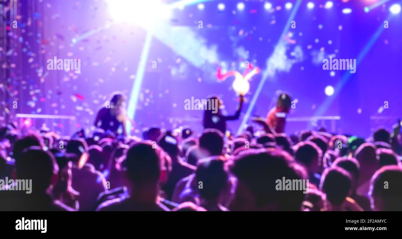 Blurred defocused people dancing at music night festival event ...