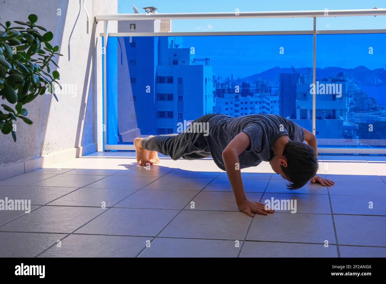 Child doing push-ups sport exercises on balcony. Sport, healhty ...