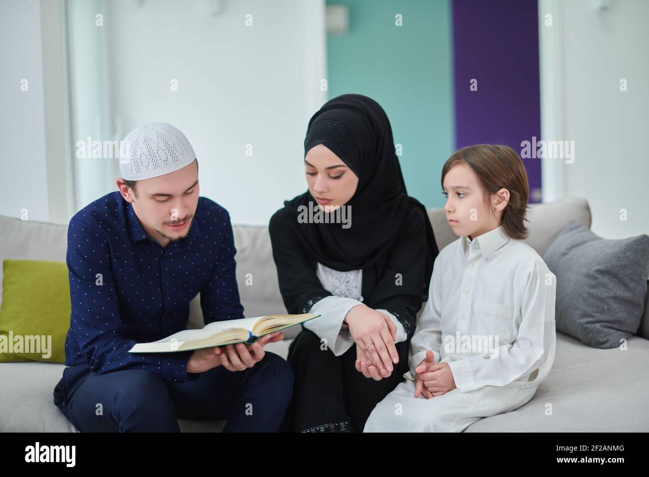 Young muslim family reading Quran during Ramadan Stock Photo - Alamy