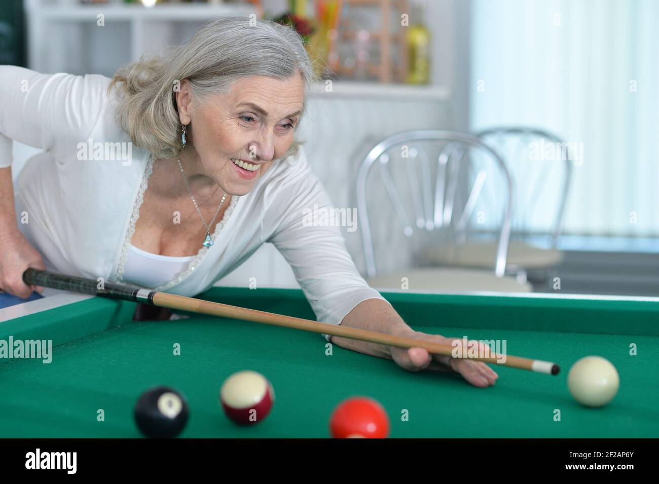 Portrait of a mature woman Playing billiard Stock Photo - Alamy