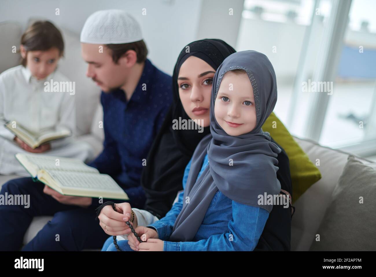 Young muslim family reading Quran during Ramadan Stock Photo - Alamy