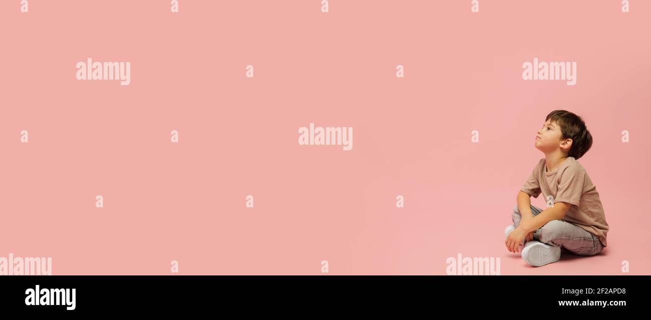 Dreaming, flyer. Happy, smiley little caucasian boy isolated on pink ...