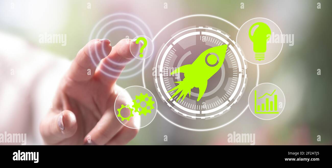 Woman touching a start up concept on a touch screen with her finger ...