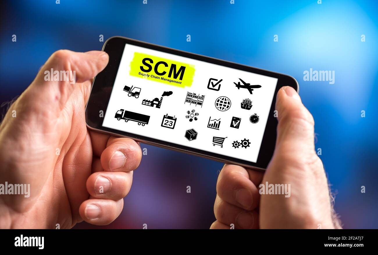 Hand holding a smartphone with scm concept Stock Photo - Alamy