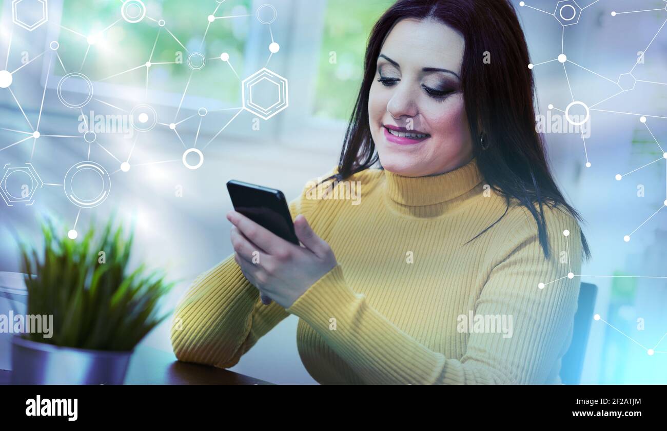 Young businesswoman using her mobile phone; light effect Stock Photo ...