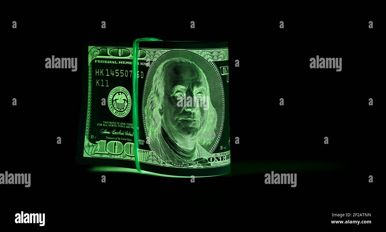One hundred dollar bills (banknotes ) close up, U.S. currency-- in UV ...