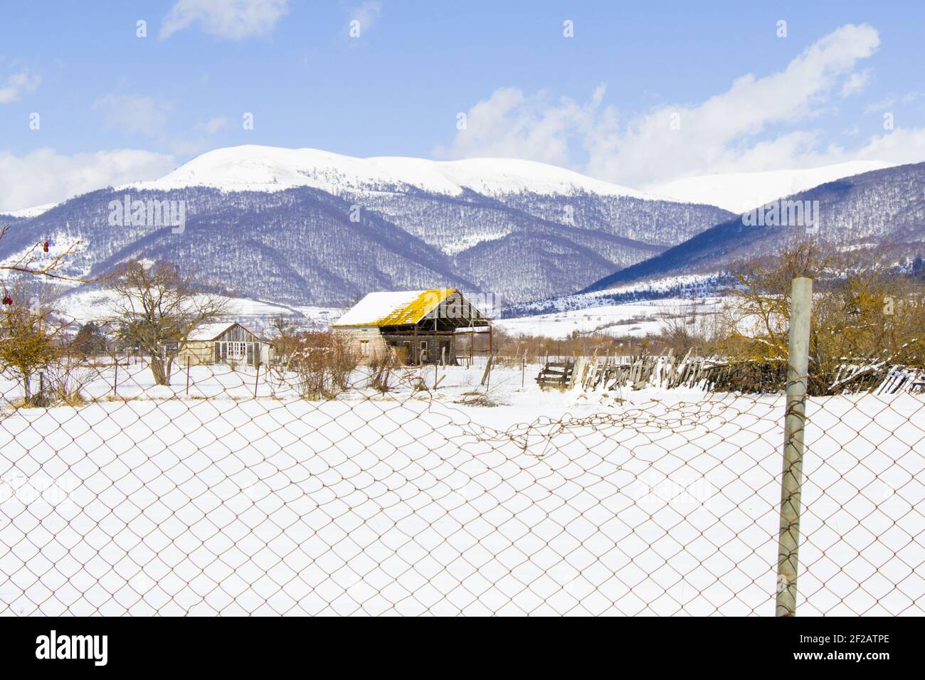 An old cottage in a village in a snowy landscape in Georgia Stock Photo ...