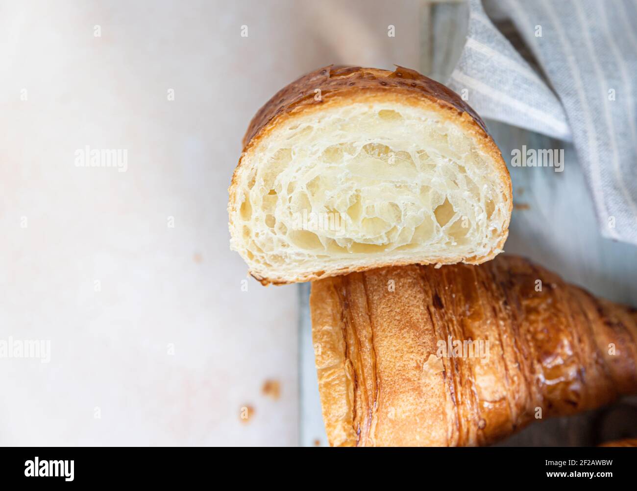 Cut in half croissant with inside texture and thin crisp layers on ...