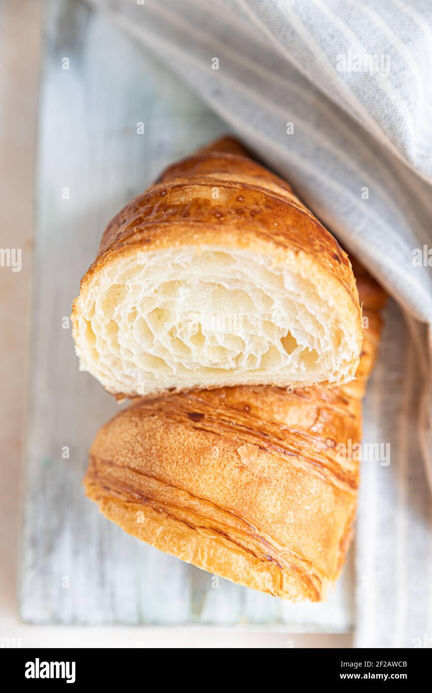 Cut in half croissant with inside texture and thin crisp layers on ...